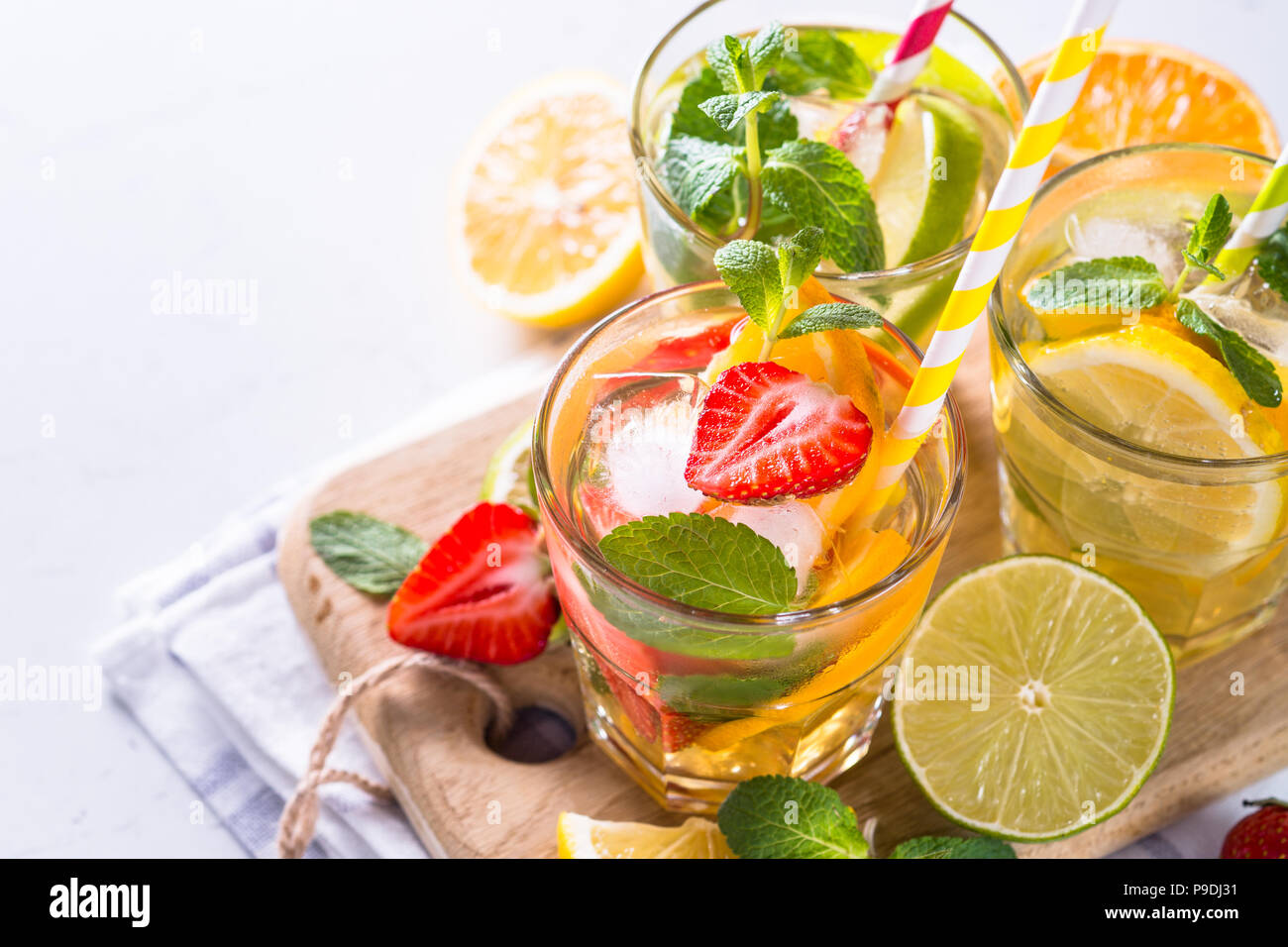 Summer drink assortment. Lemonade, mojito and strawberry lemonade in ...