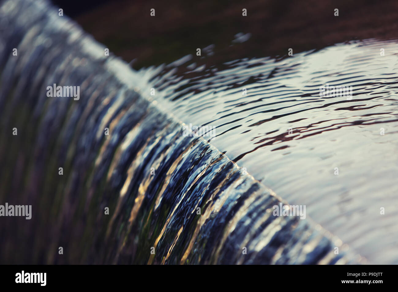 Line drop of water flow from the jets in the shallows of a waterfall on ...