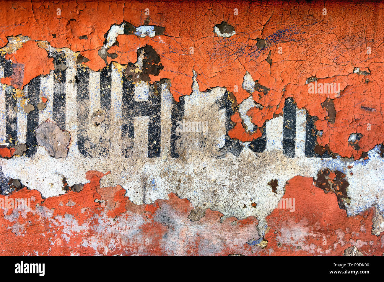 Latvia, Riga. Letters from the past on the white facade of the house ...