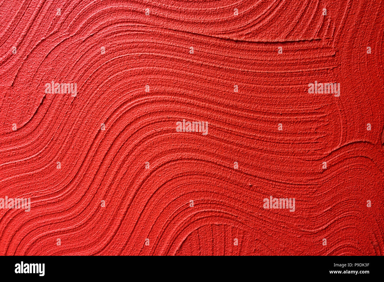 Painted in different directions in different waves of red wall Stock ...