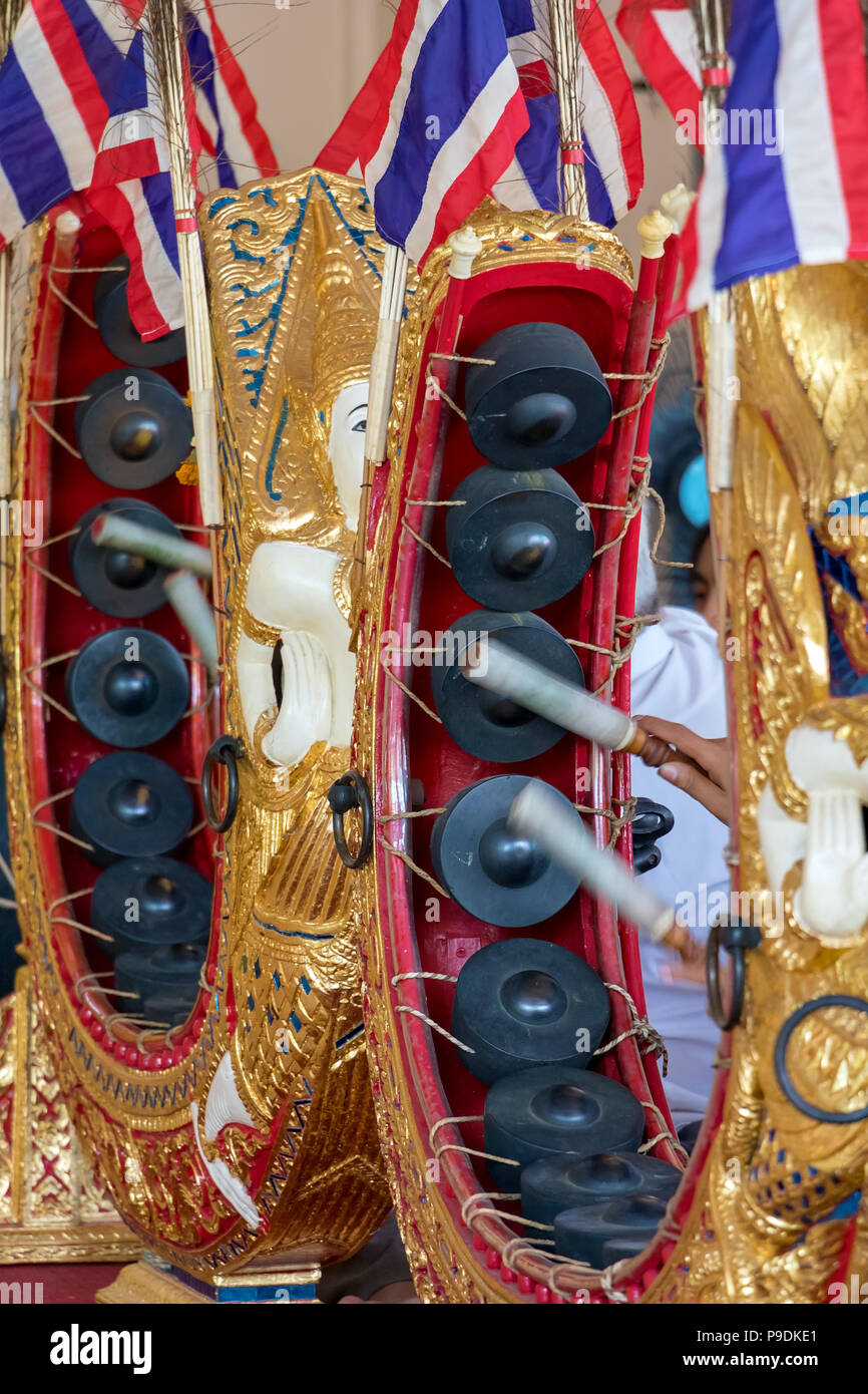 Playing a traditional musical instrument Khong Wong on the background ...