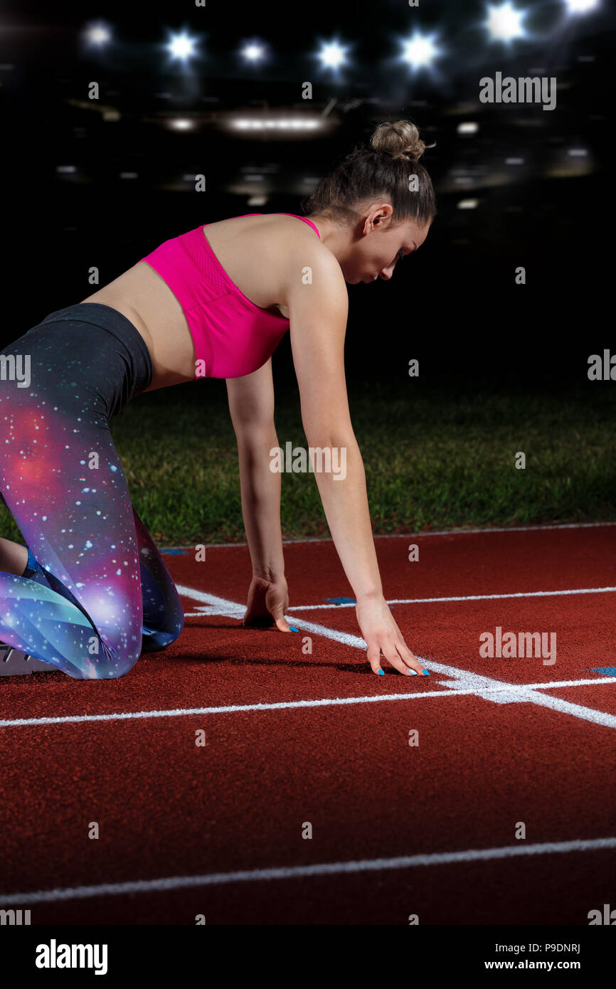 Female sprinter leaving starting blocks hi-res stock photography and ...