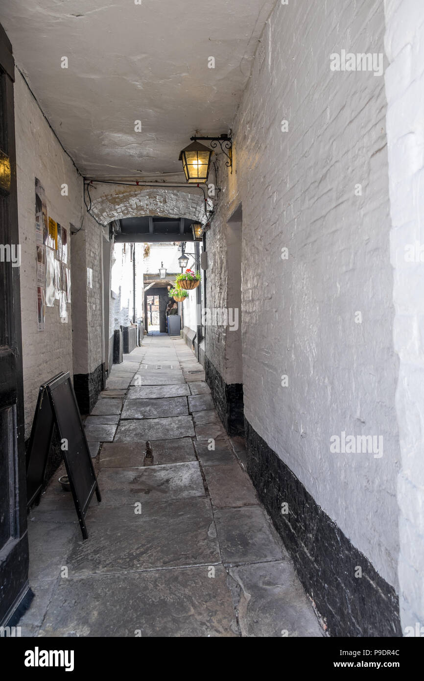 Alley way with small light in the roof Stock Photo - Alamy