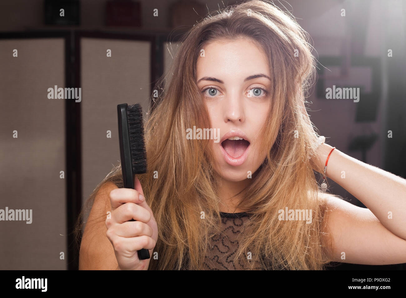 stressed pretty girl touching flowing disheveled hair Stock Photo - Alamy