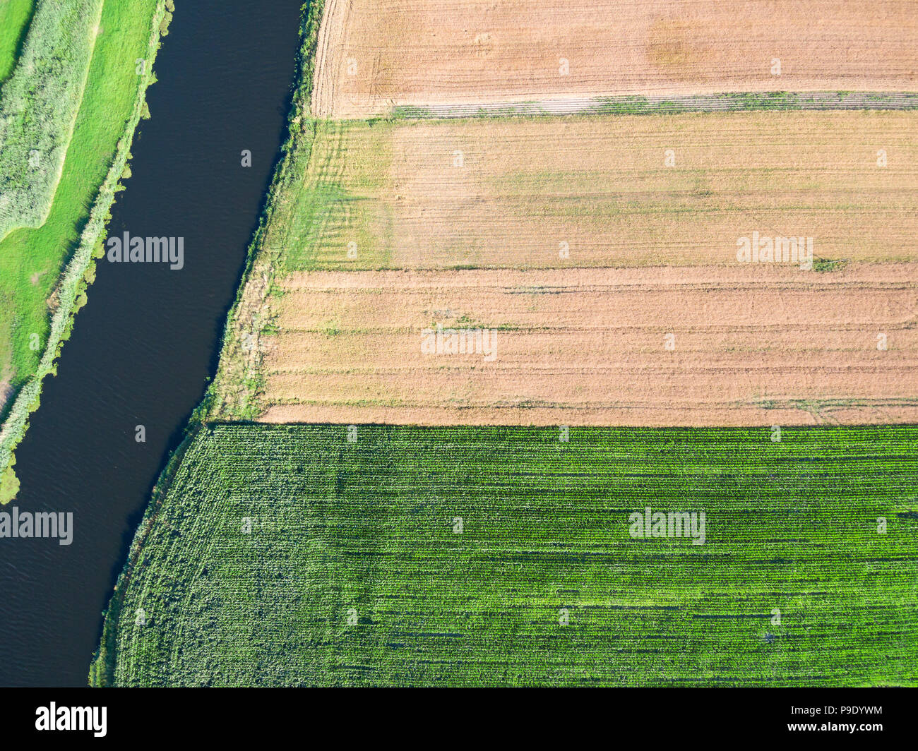 Fields by a river view directly from above Stock Photo - Alamy