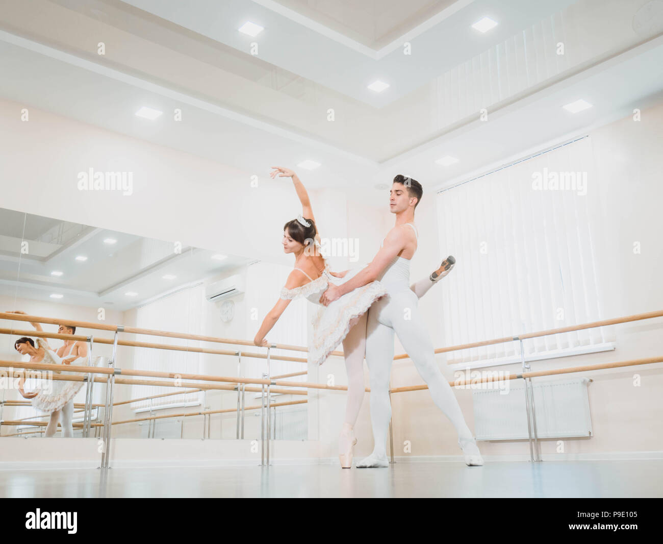 Professional, emotional ballet dancers practicing in the gym or hall ...