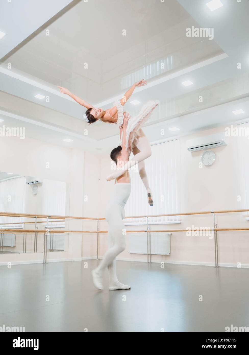 Professional, emotional ballet dancers practicing in the gym or hall ...