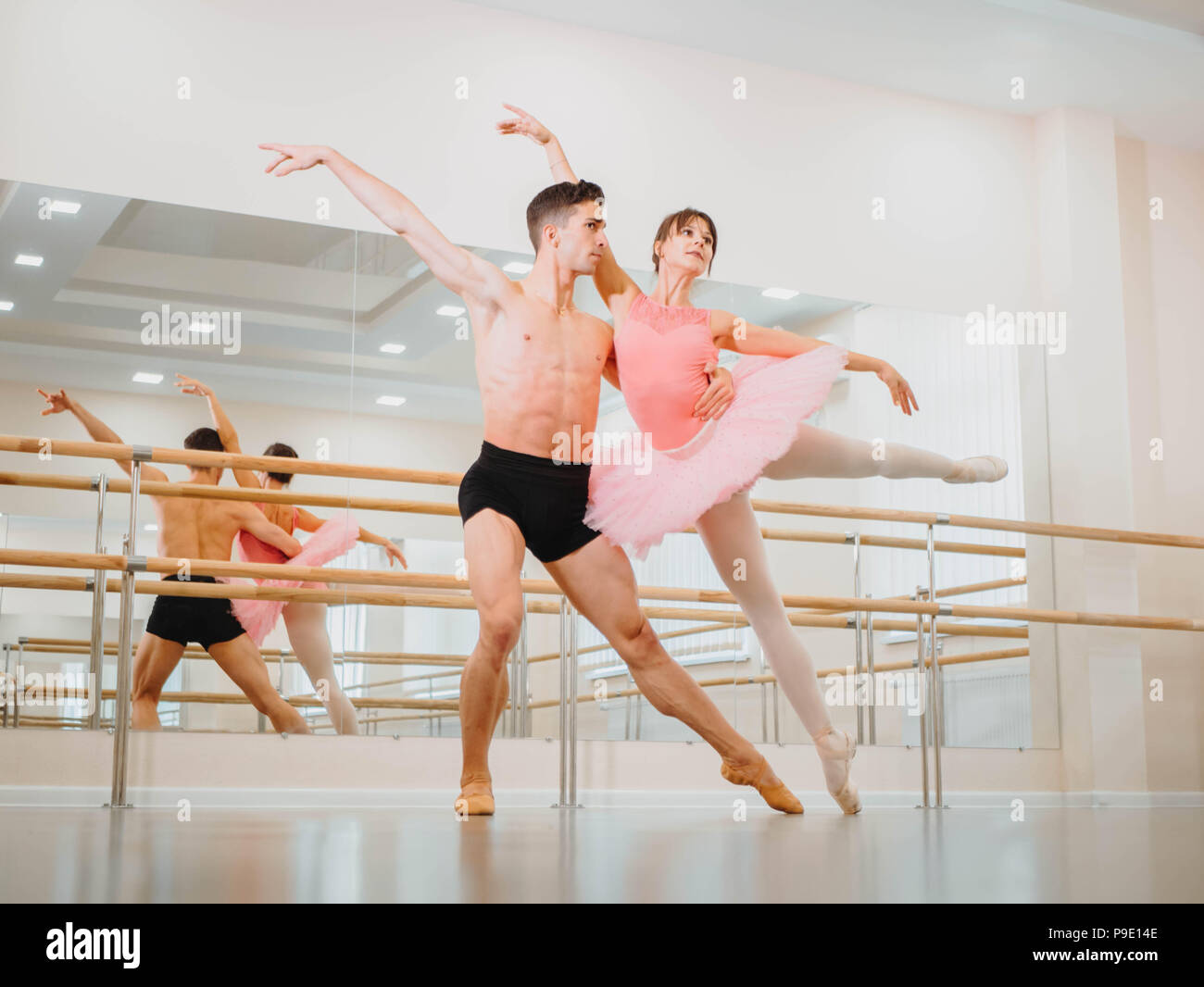 Professional, emotional ballet dancers practicing in the gym or hall ...
