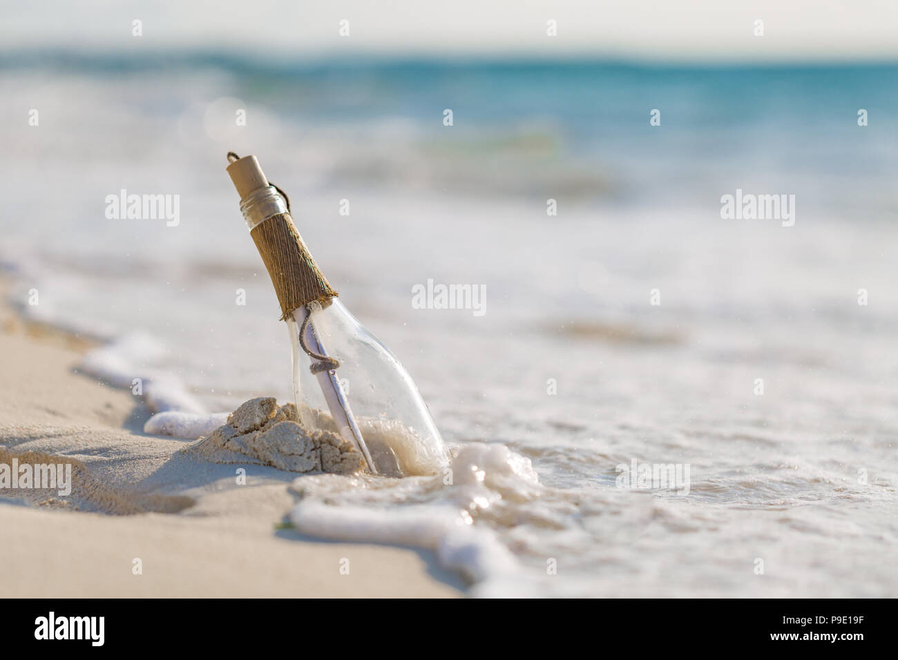 Message in bottle on beach with white sand, in tropical sea. Castaway ...