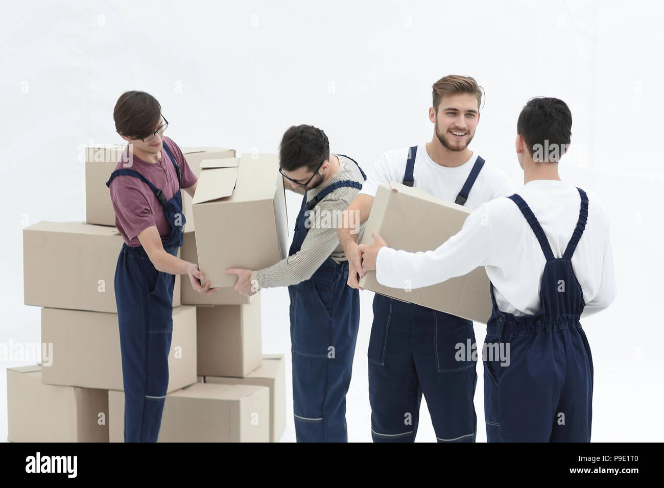 Movers lifting stack of cardboard moving boxes isolated on white Stock ...