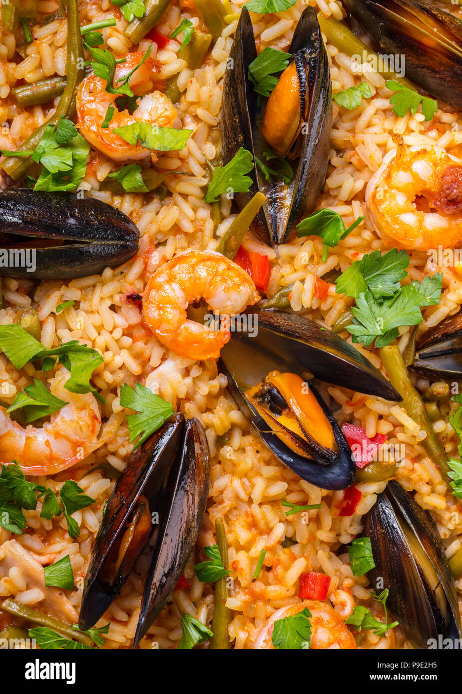 food background, paella with seafood and vegetables close-up Stock ...