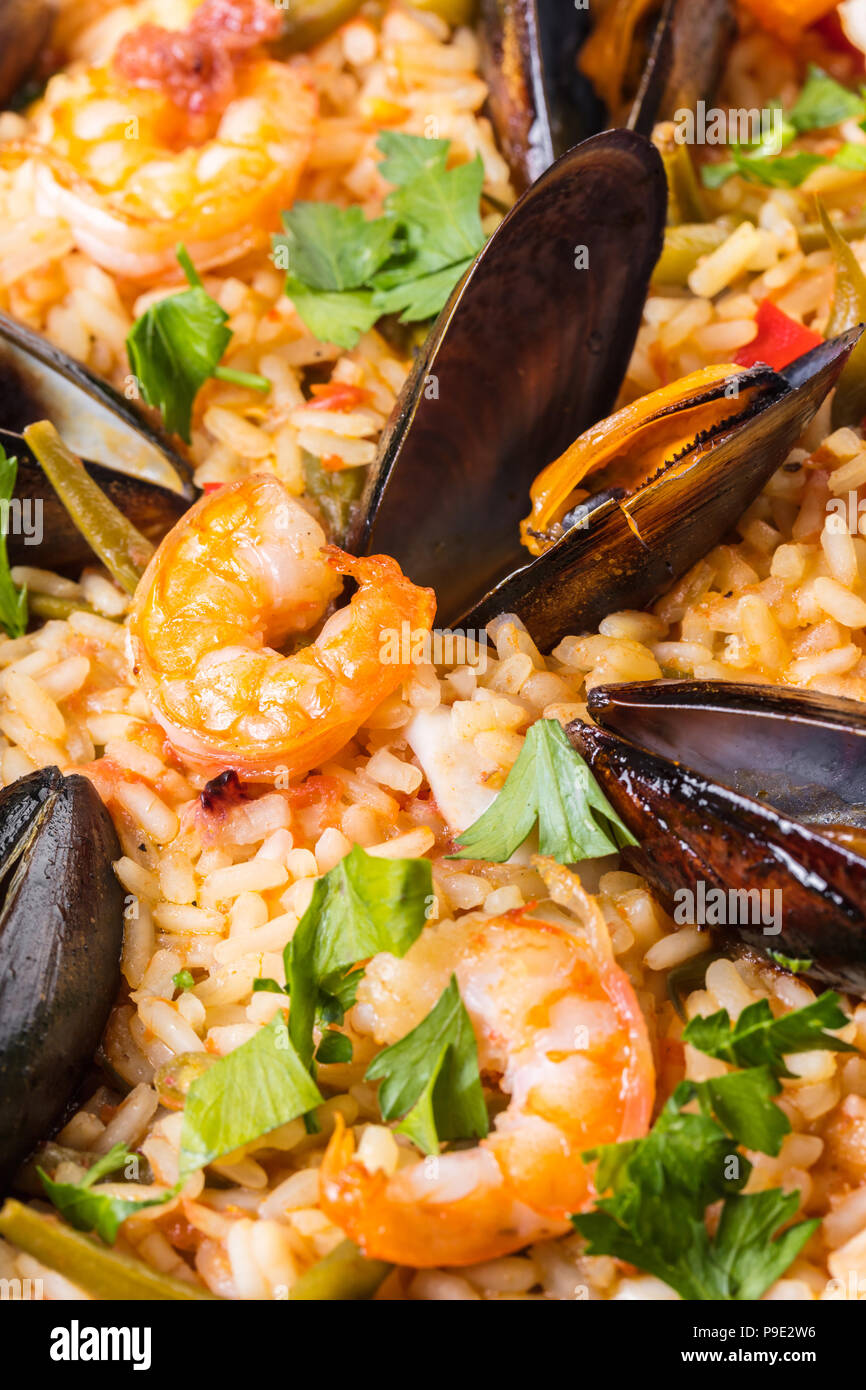food background, paella with seafood and vegetables close-up Stock ...