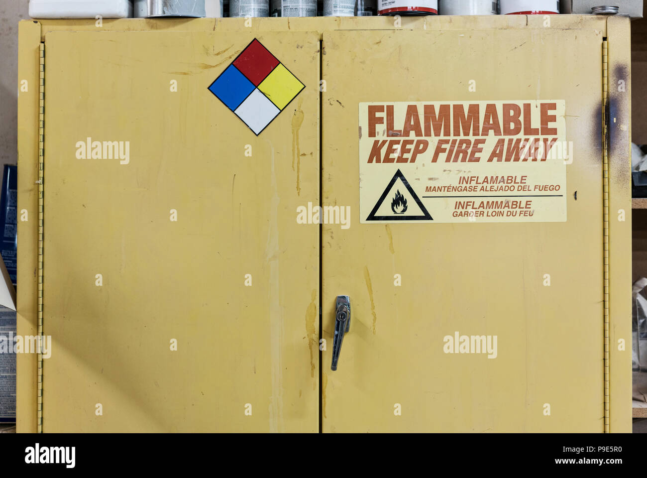 Safety sign reminders mounted to a metal cabinet in a woodworking ...