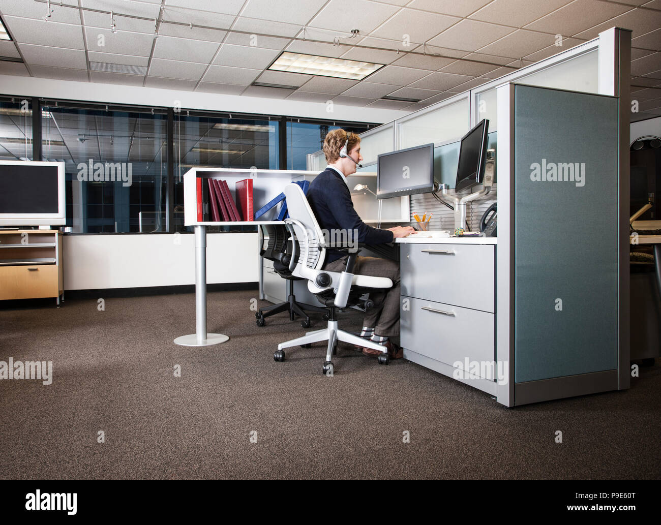 Caucasian businessman working at his computer while sittig in his ...