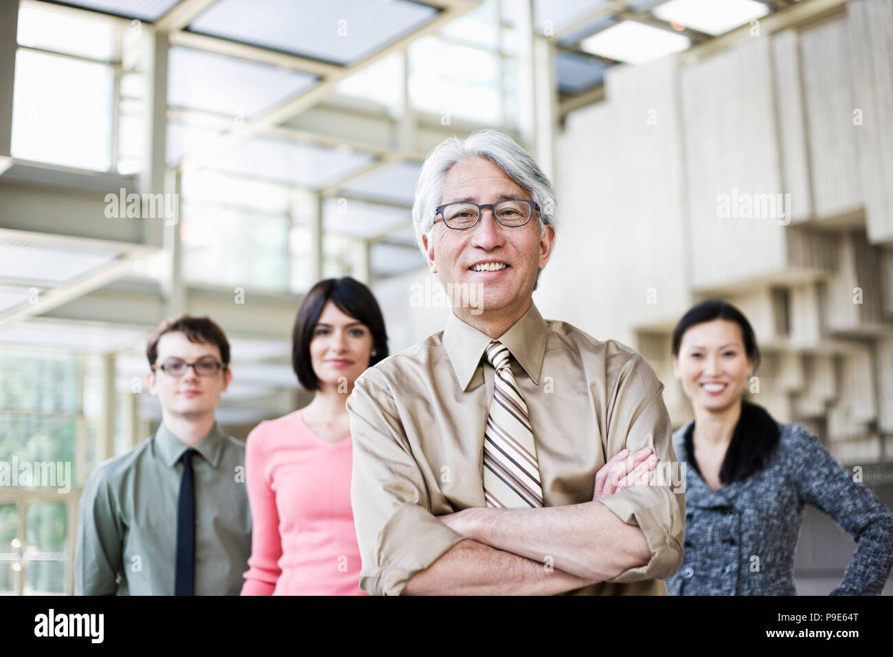 A portrait of a mixed race team of business people standing in the ...