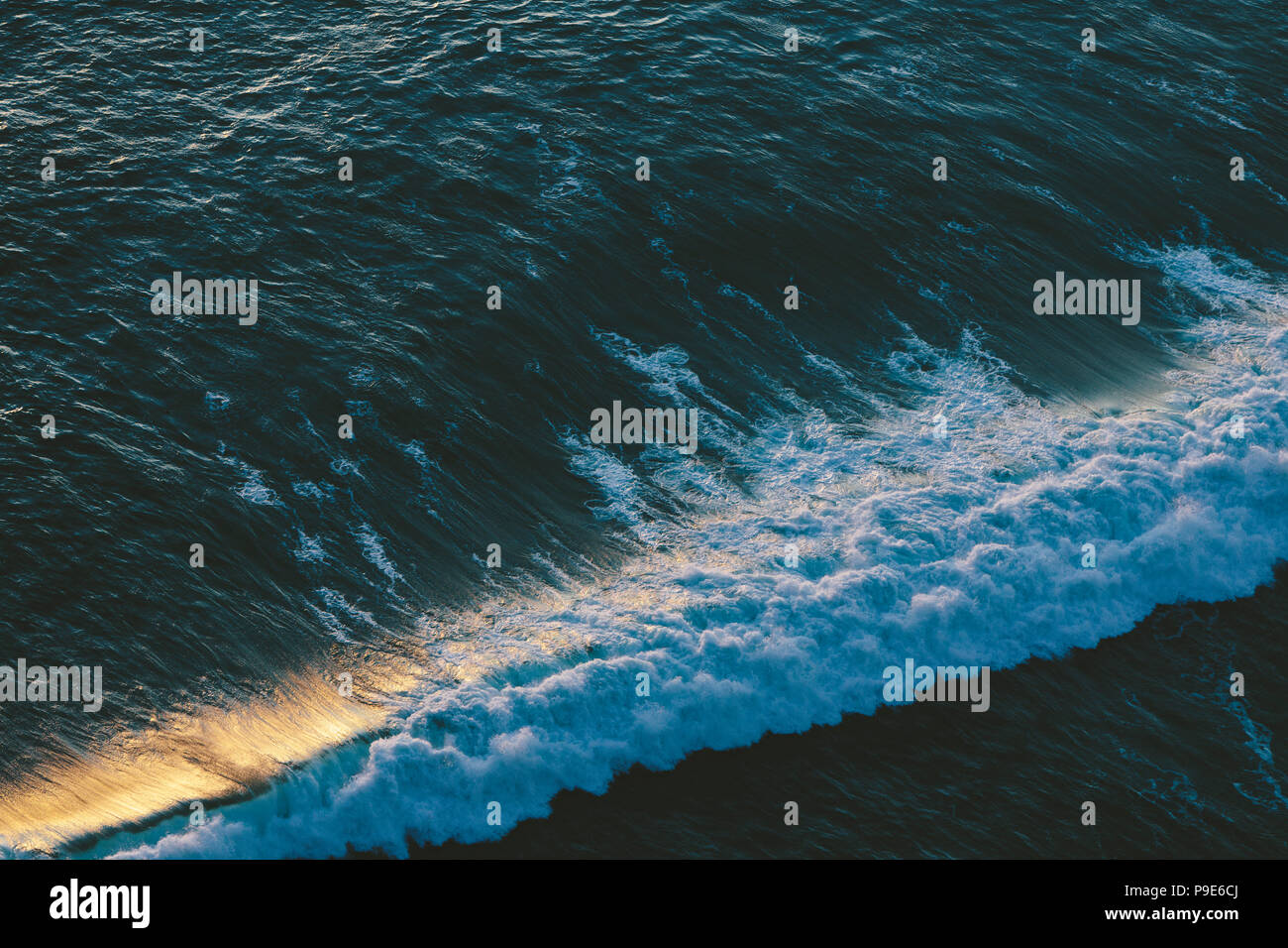 Seascape abstract at dusk, surf breaking on the shore, overhead view ...
