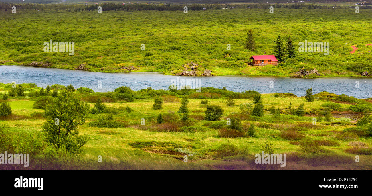 Small red building in Iceland landscape next to river Stock Photo - Alamy