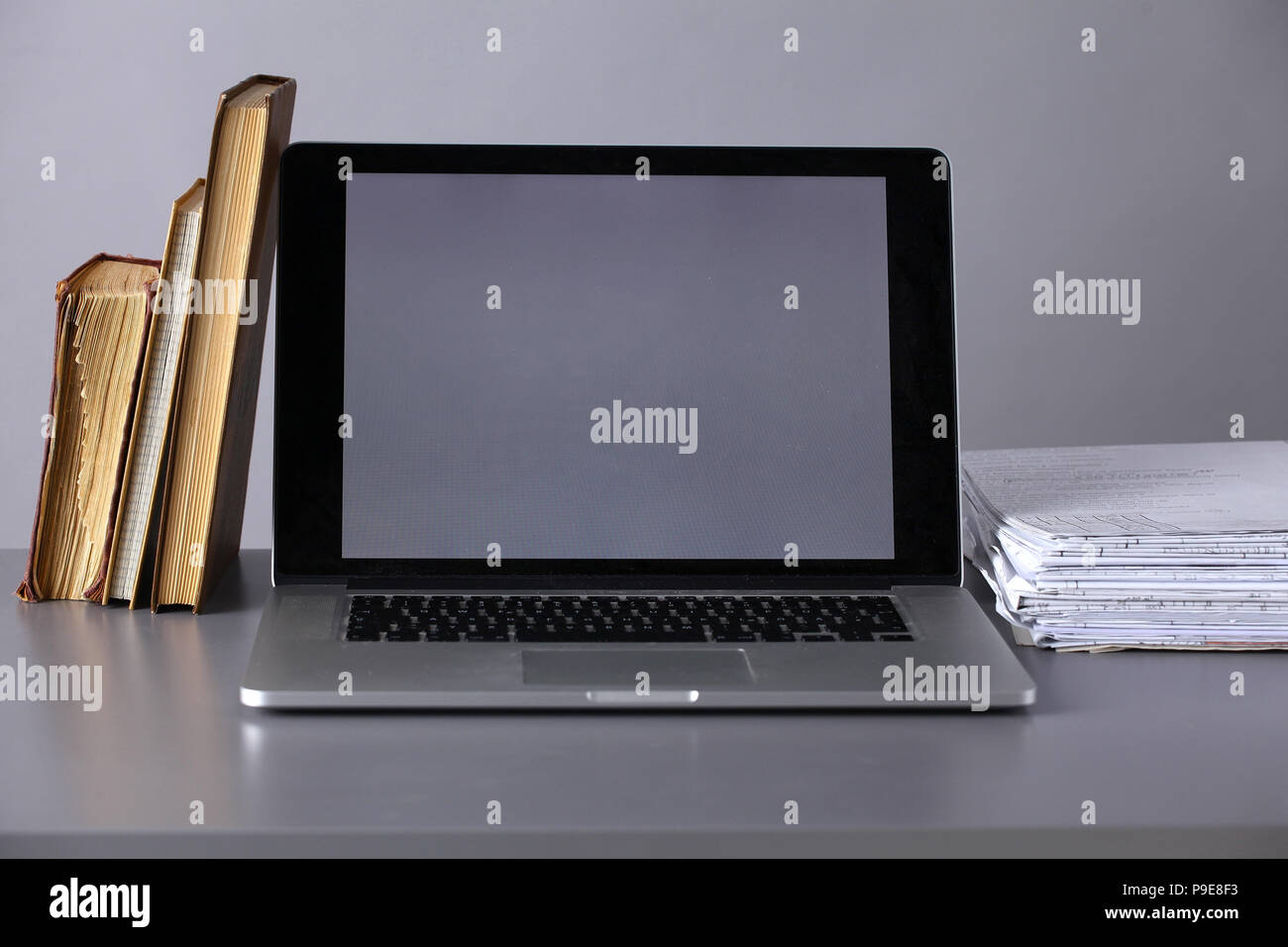Workspace with computer and stack of papers in office Stock Photo - Alamy