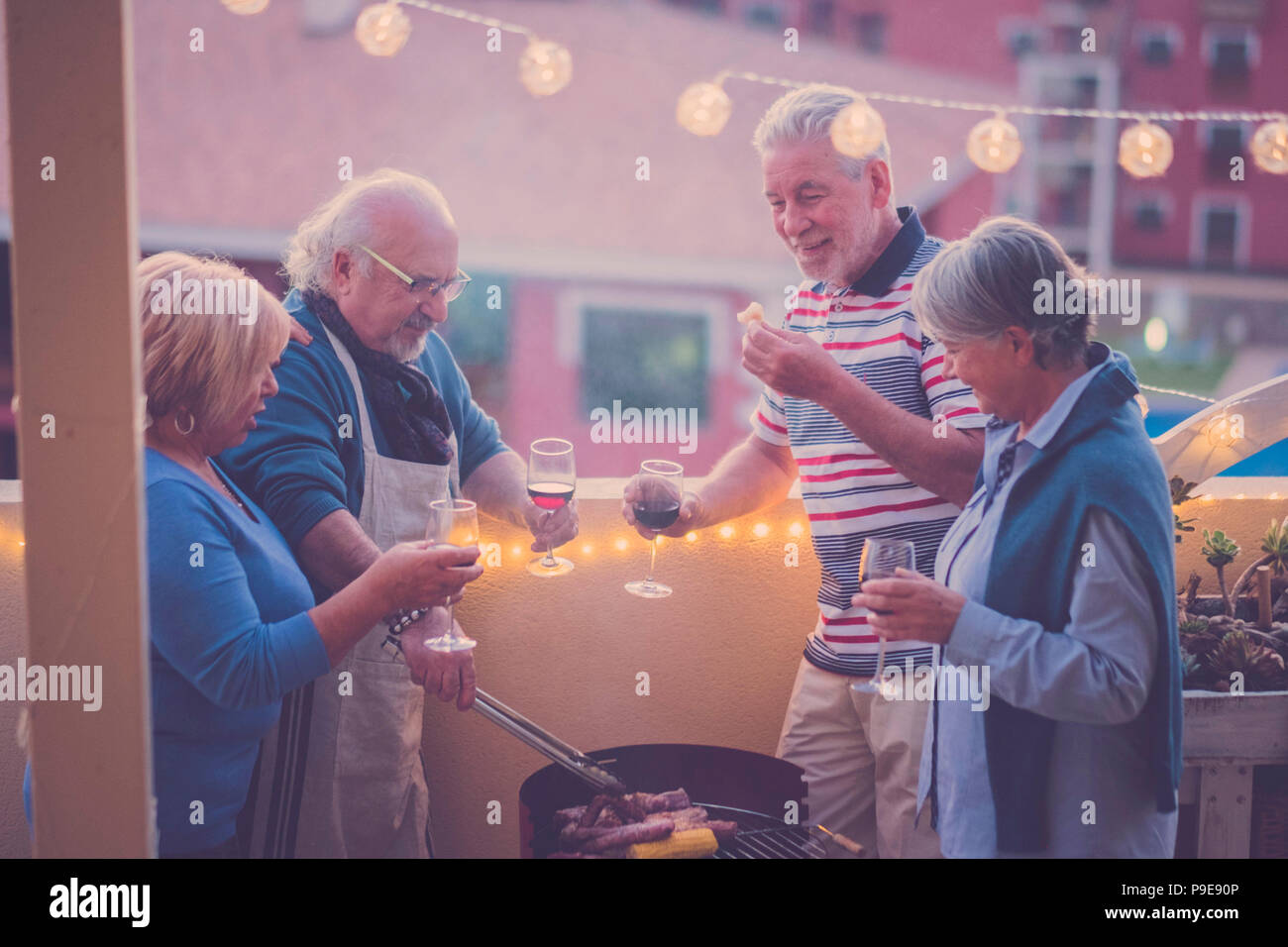 senior adult people group in leisure activity doing barbeque bbq on the ...