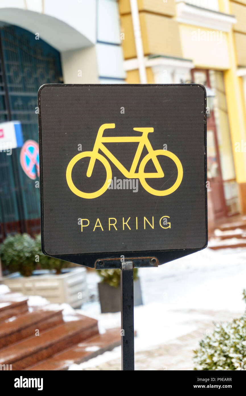 square yellow bicycle parking sign on the street Stock Photo - Alamy