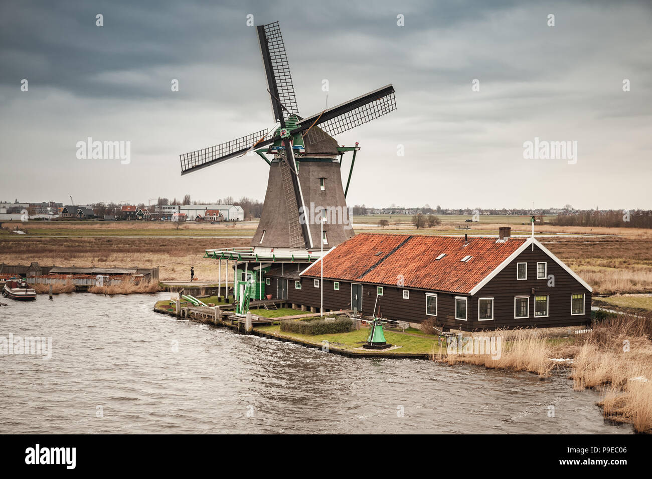 Windmill on Zaan river coast, Zaanse Schans town, popular tourist ...