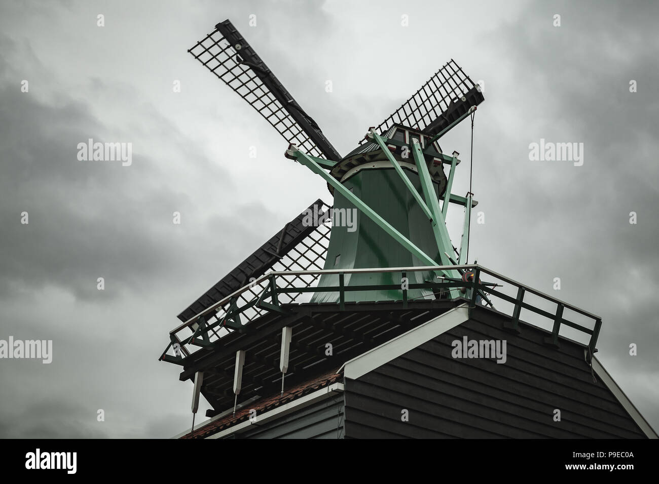 Windmill under dramatic cloudy sky. Zaanse Schans town, popular tourist ...