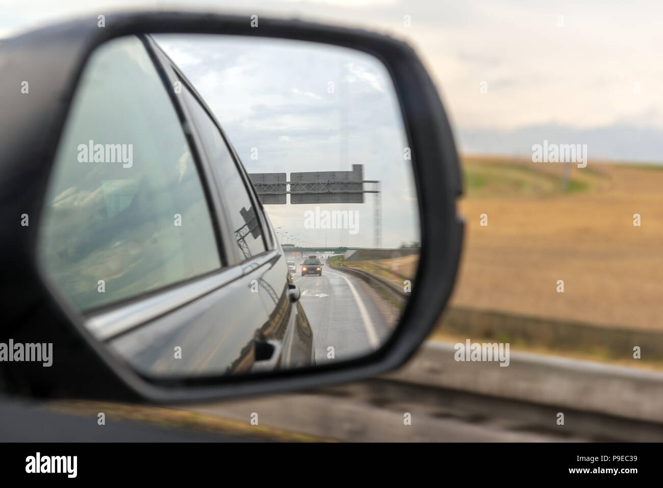 Asphalt road reflected in car mirror Stock Photo - Alamy