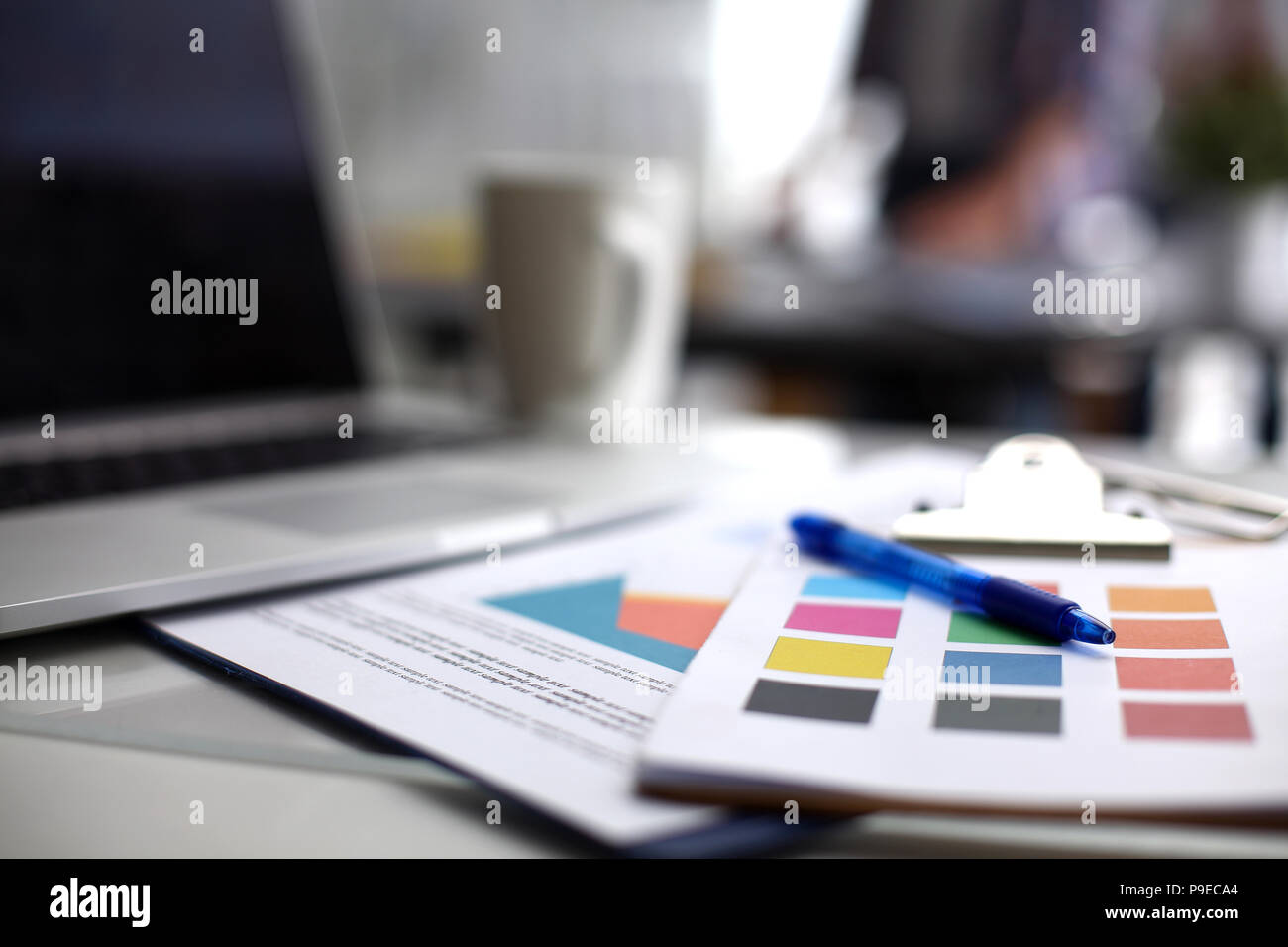 Laptop computer with folder on desk Stock Photo - Alamy
