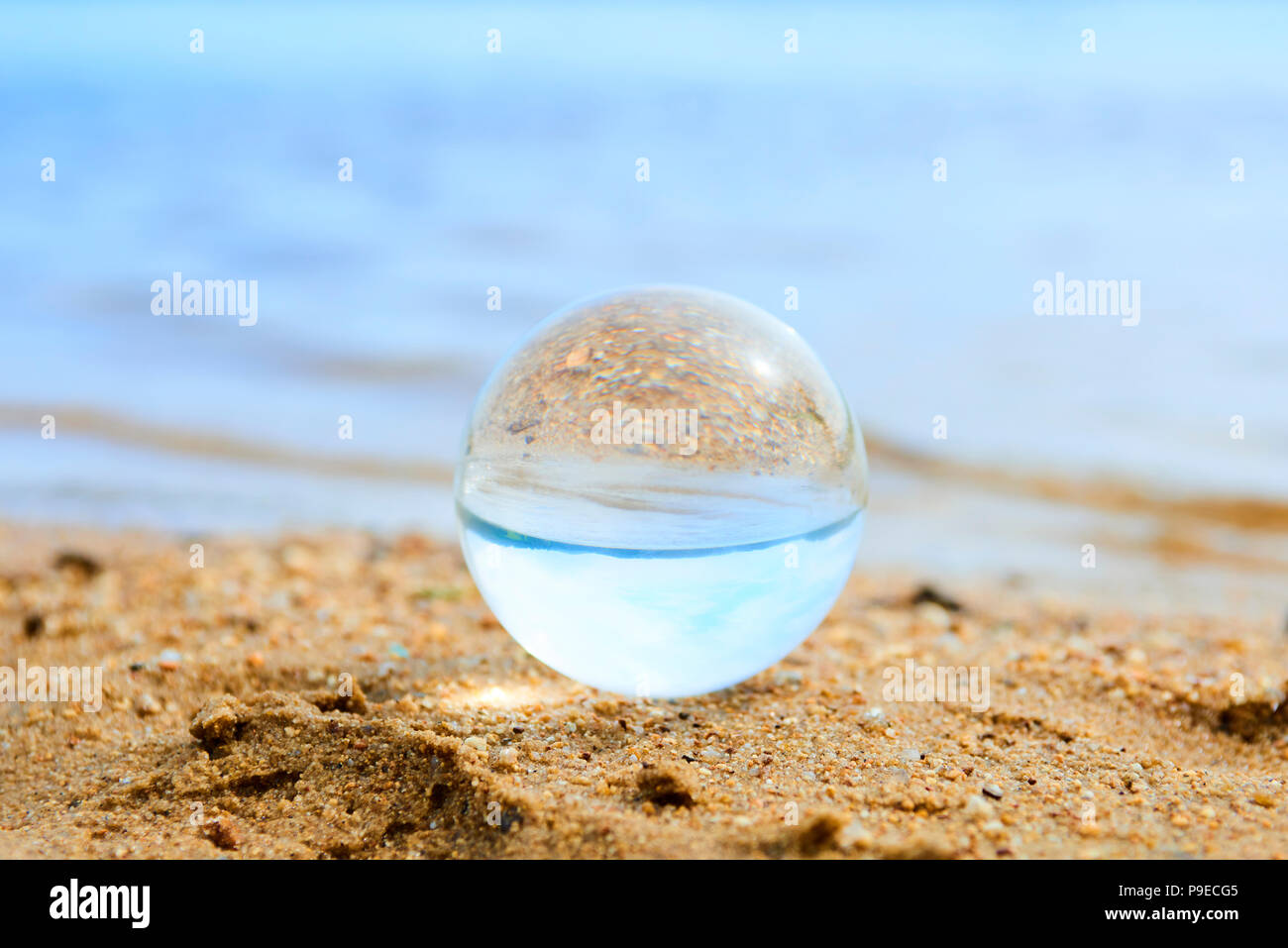 Glass ball at the sand beach Stock Photo - Alamy
