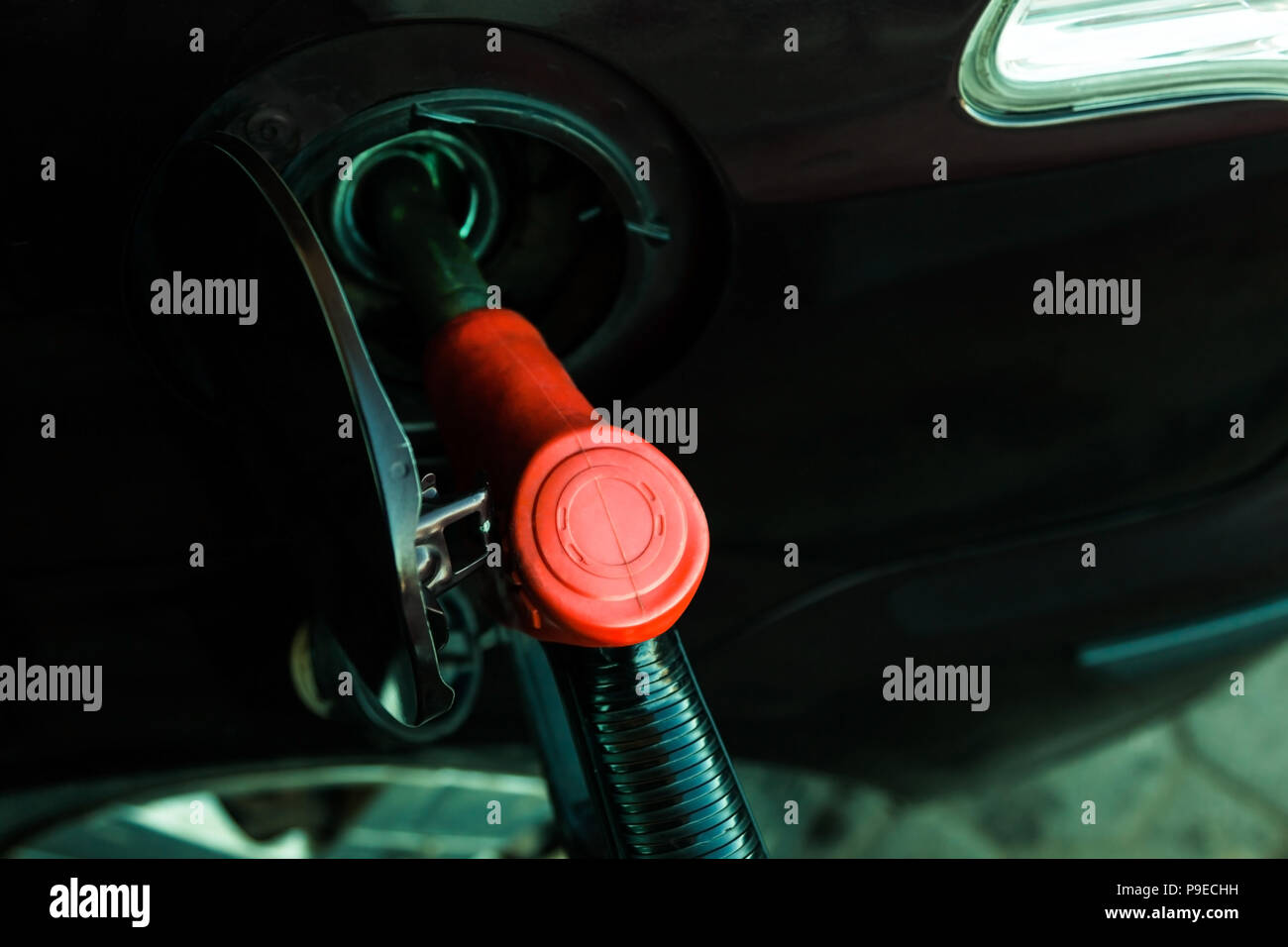 Refueling gun in the tank of the machine Stock Photo - Alamy
