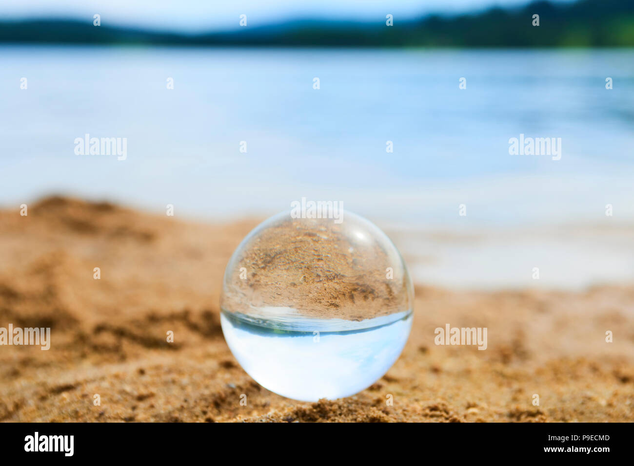 Glass ball at the sand beach Stock Photo - Alamy