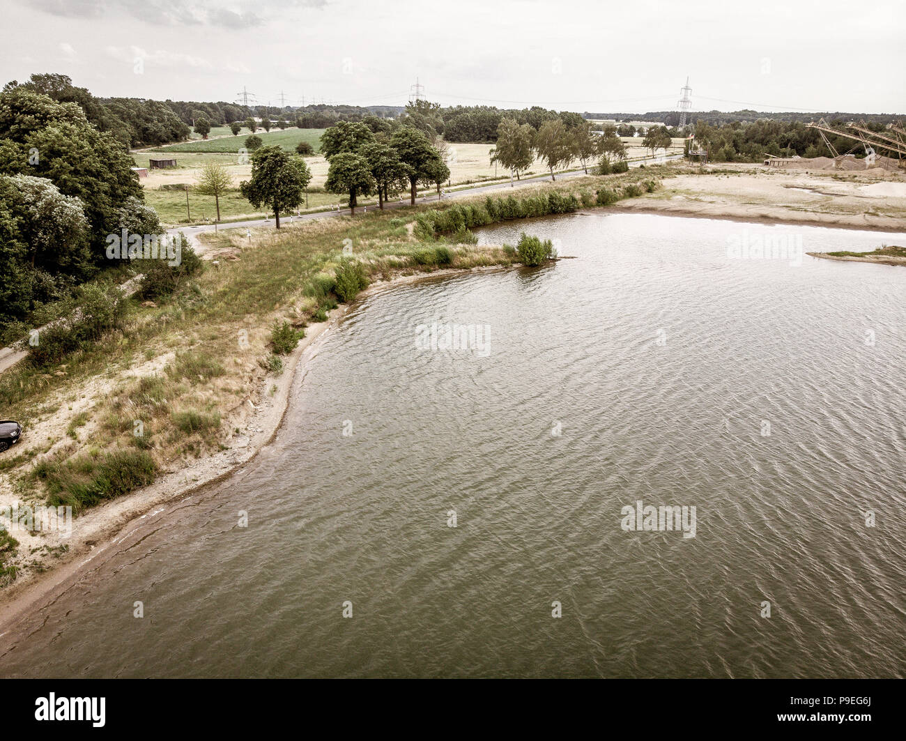Aerial view of a path next to a gravel pond, made with drone Stock ...