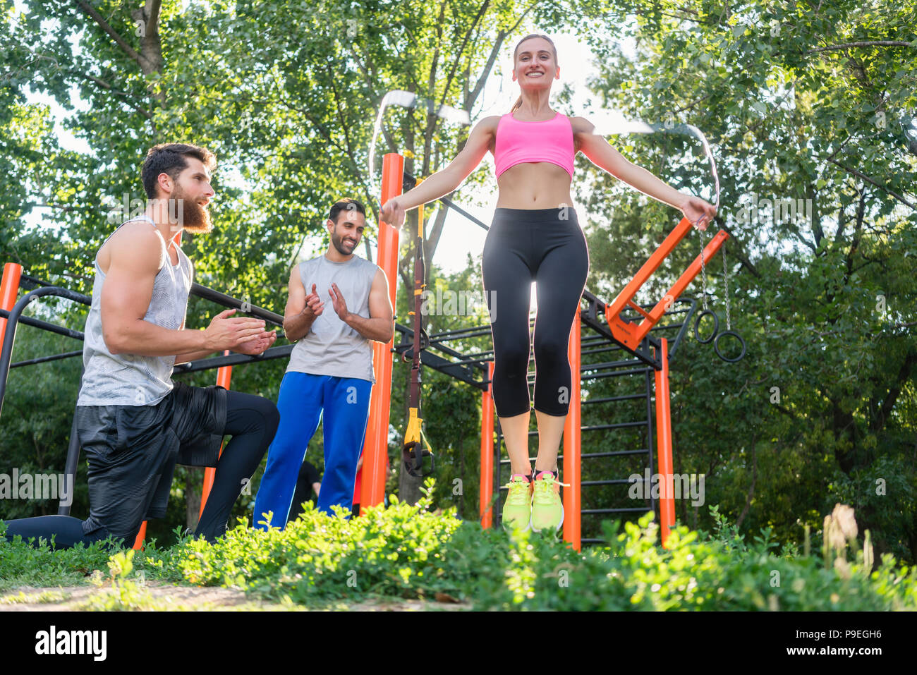 Beautiful woman jumping rope in the applauses of her friends during ...