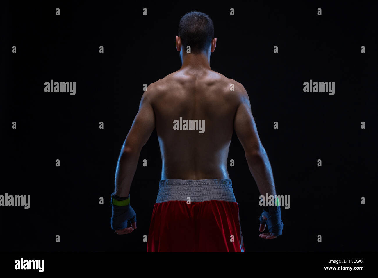 Rear view of strong young male boxer. Fitness male model wearing boxing ...