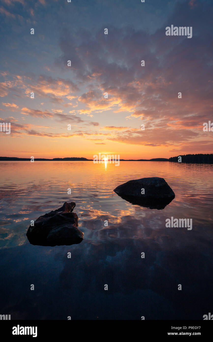 Very beautiful landscape image of a sunset behind calm mirror clear ...