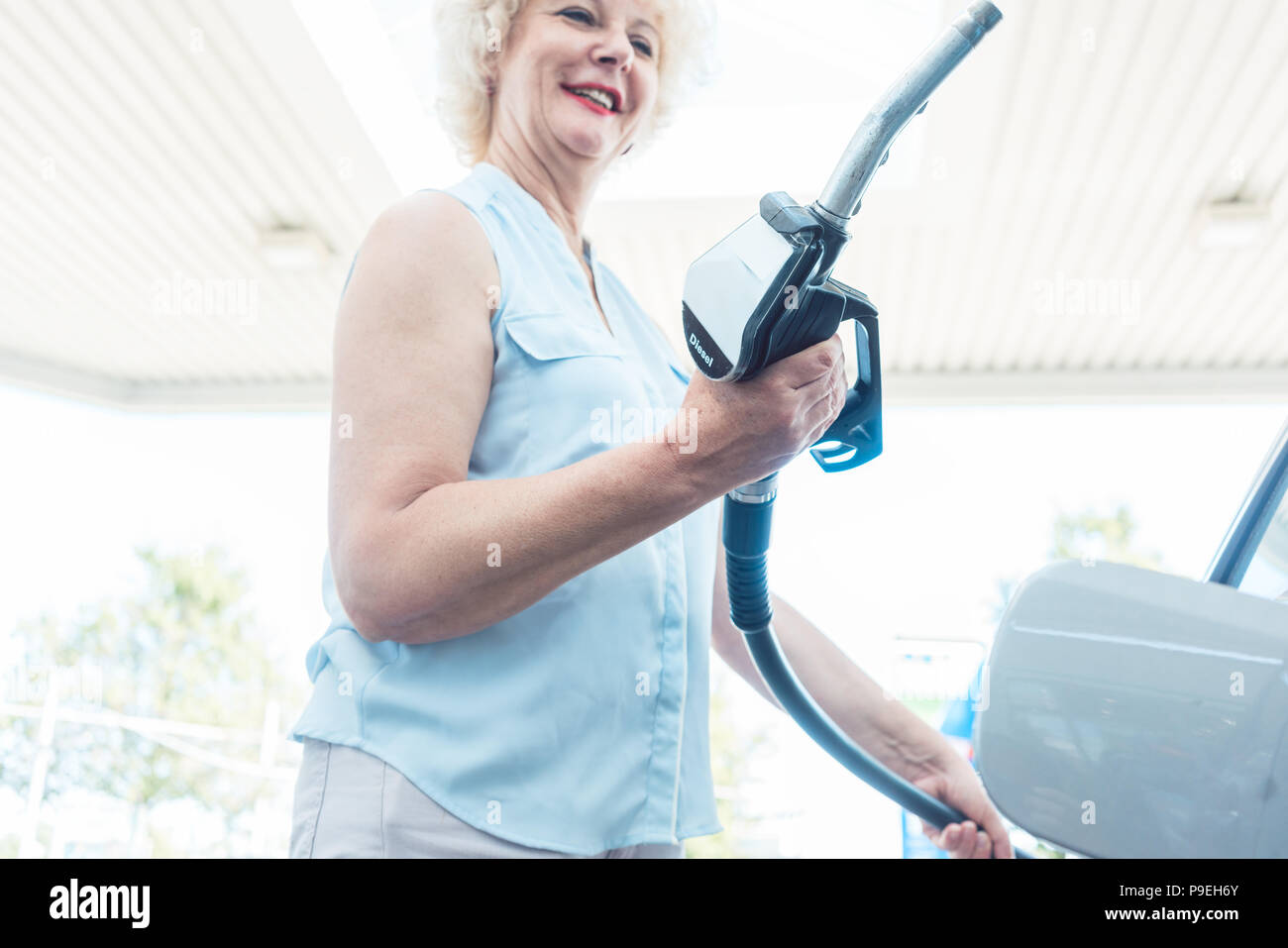 Hand holding gas fuel pump nozzle hi-res stock photography and images ...