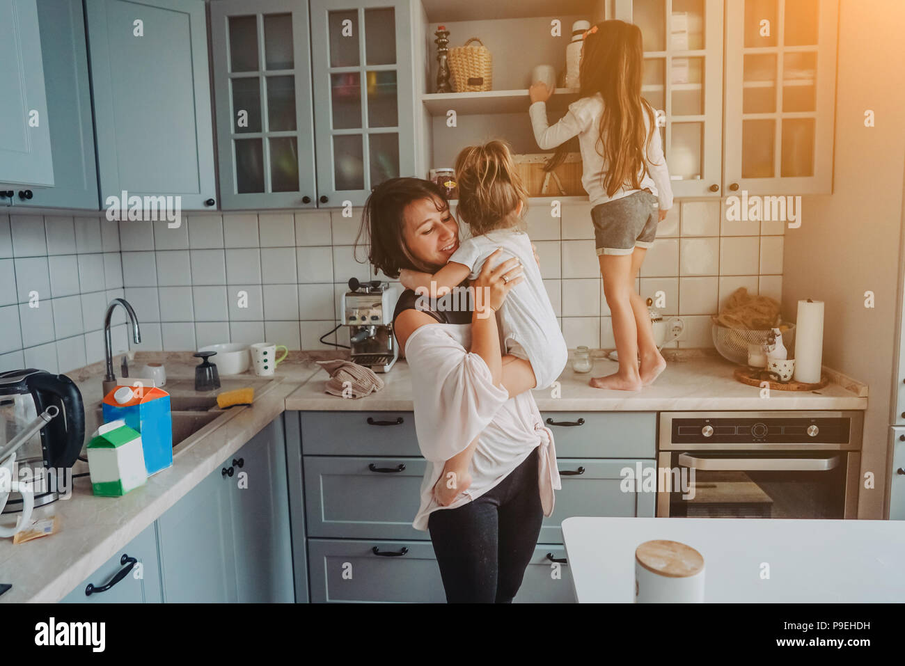 Happy family having fun in the kitchen Stock Photo - Alamy