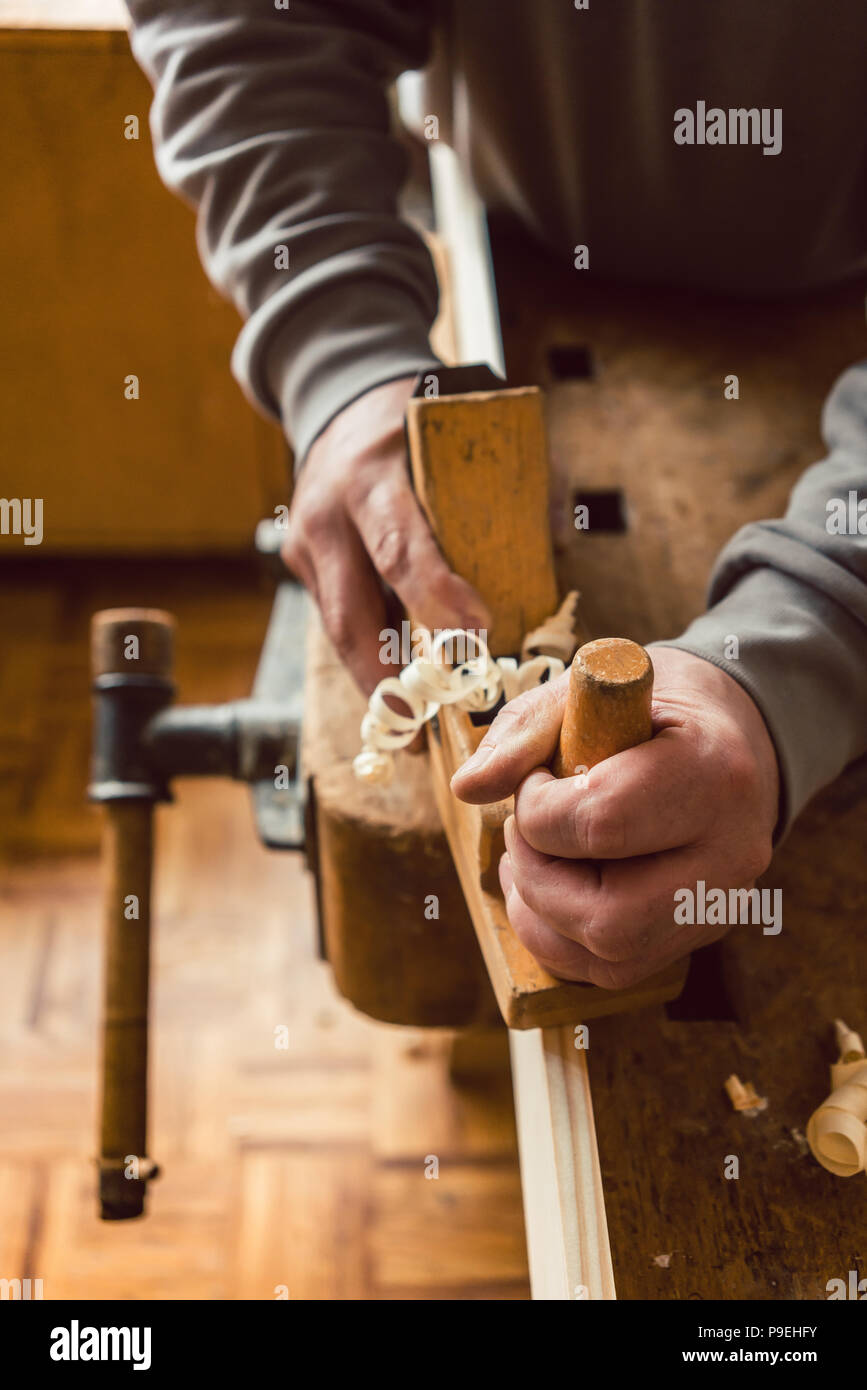 Top view of carpenter hand working with wood planer Stock Photo - Alamy