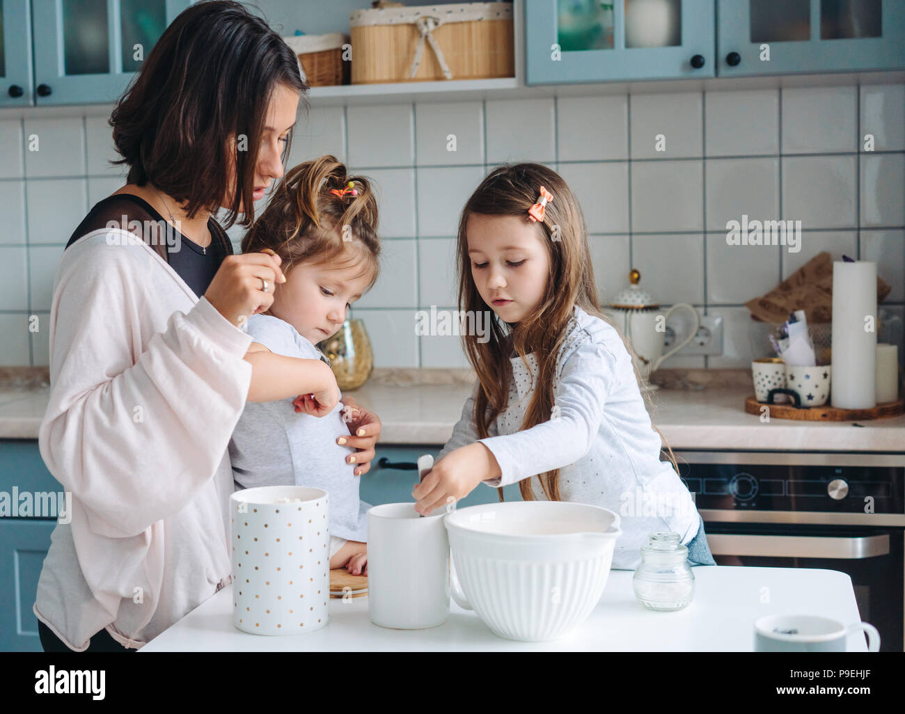 Happy family cook together in the kitchen Stock Photo - Alamy