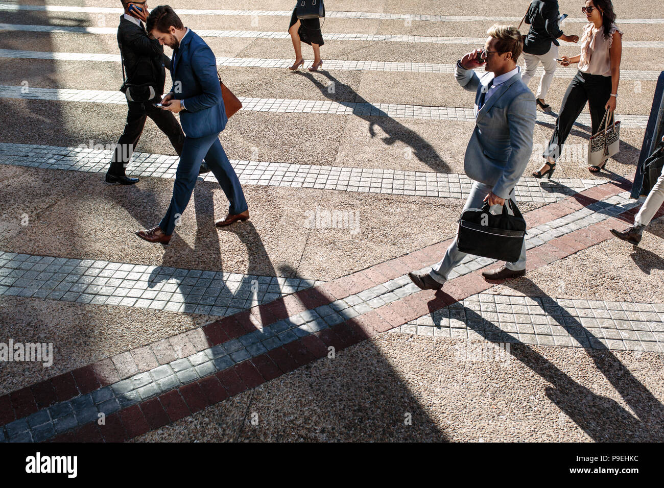 Business people commuting to office in the morning carrying office bags ...