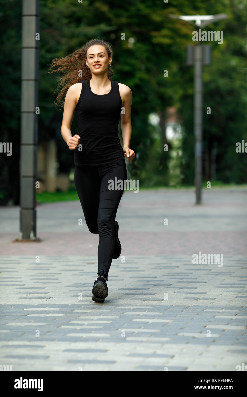 young attractive woman running Stock Photo - Alamy