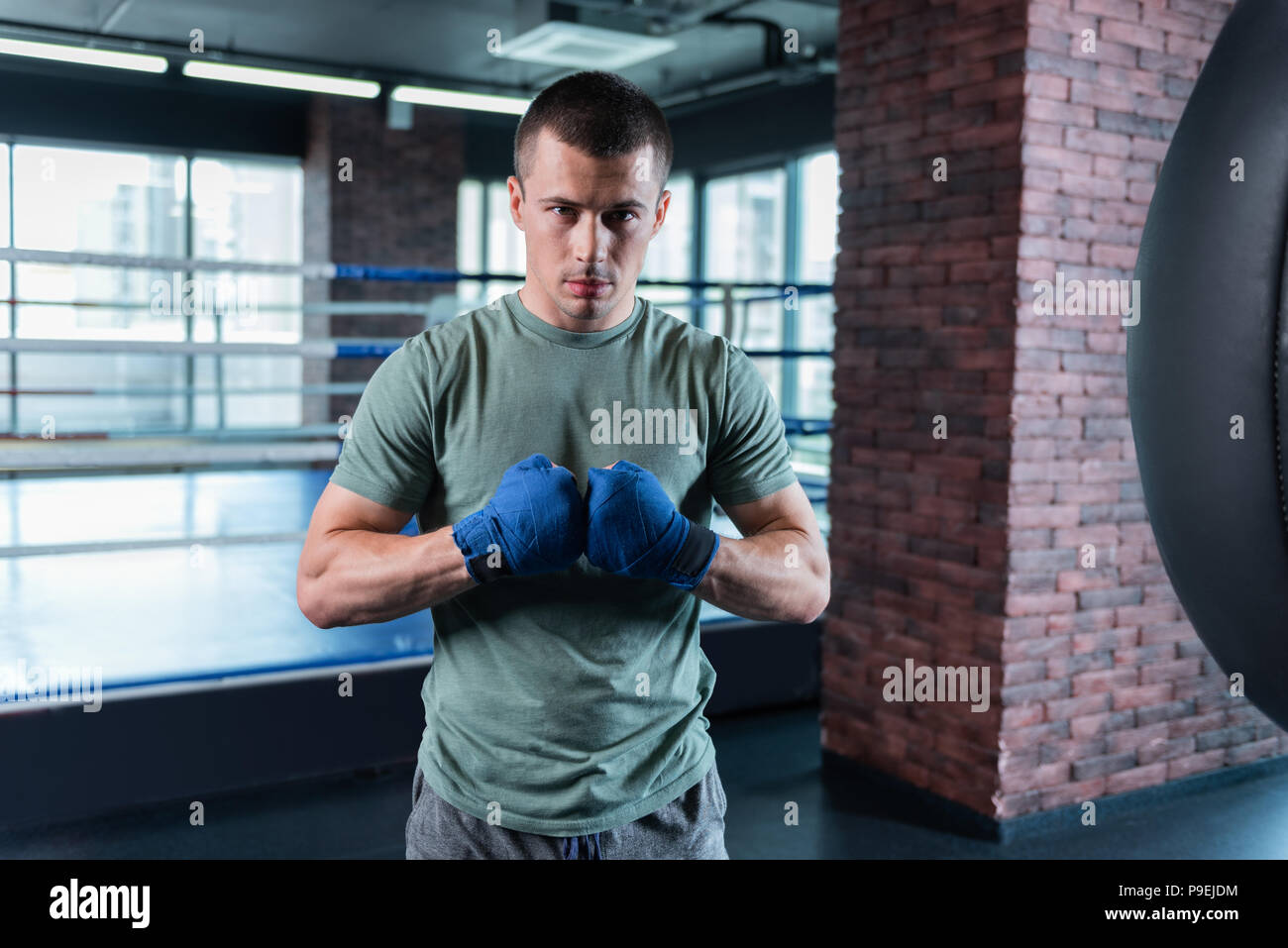 Dark-eyed athlete motivating himself for important boxing competition ...