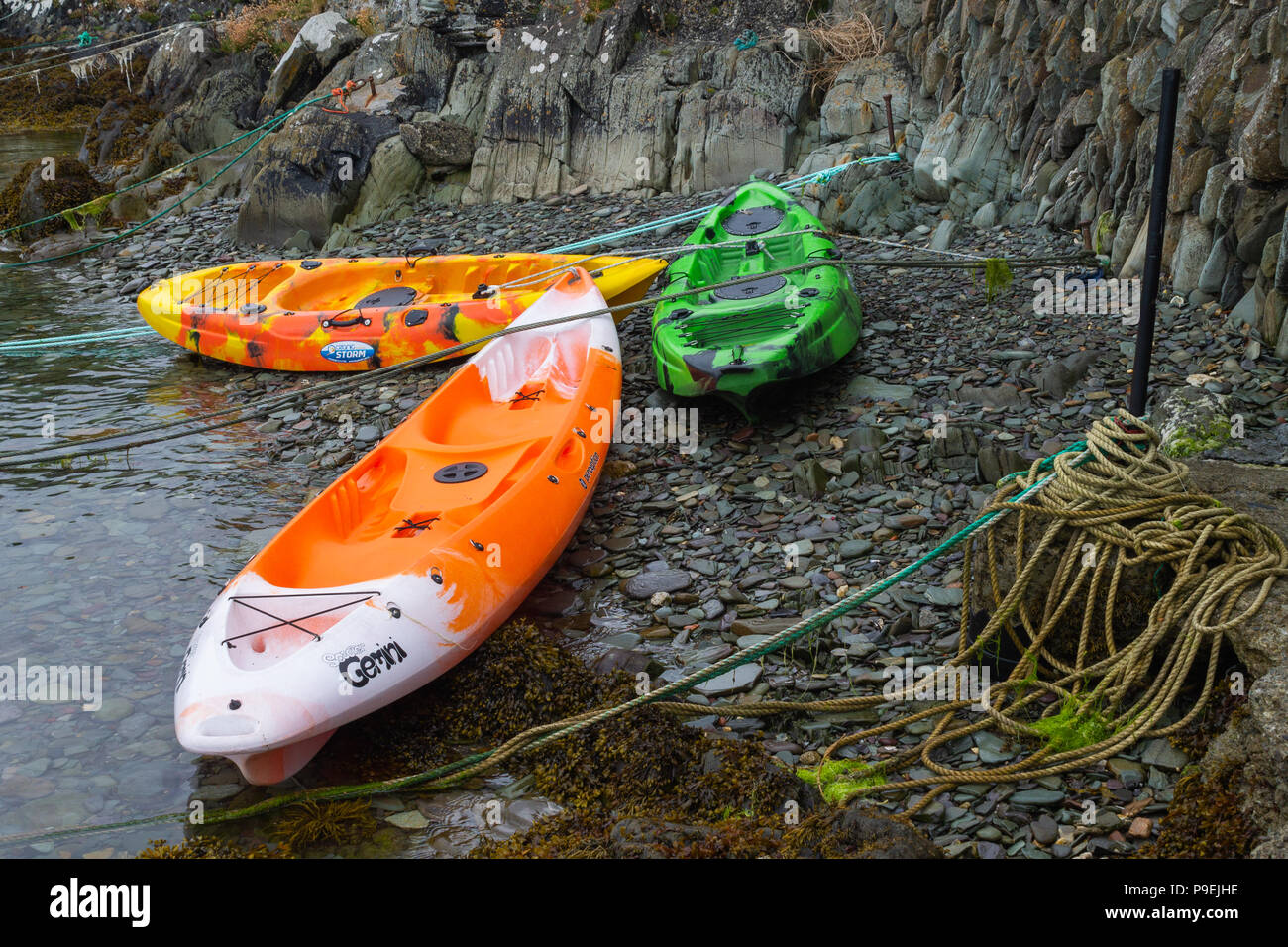 plastic kayaks left on a shingle beach Stock Photo - Alamy
