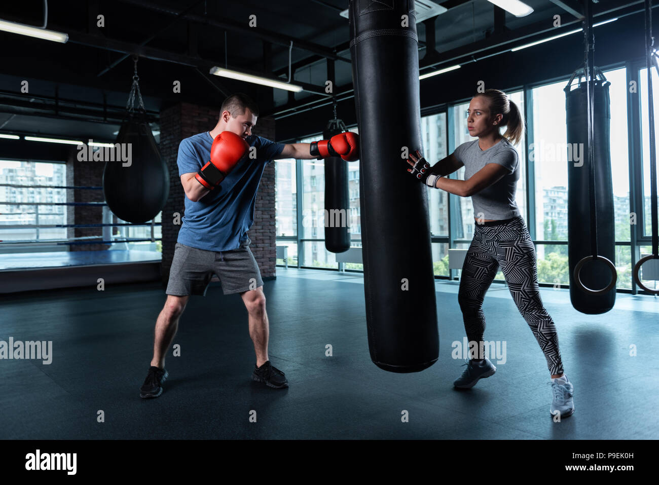 Professional sport trainer wearing leggings working with client Stock ...