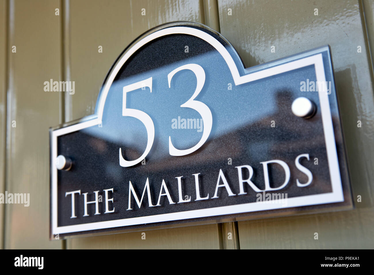 A plaque showing the number 53 & the name "The Mallards" on a green ...