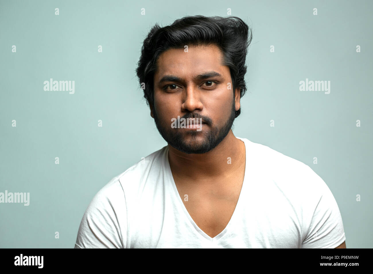 Close Up Portrait Of Attractive Indian Man With Serious Face