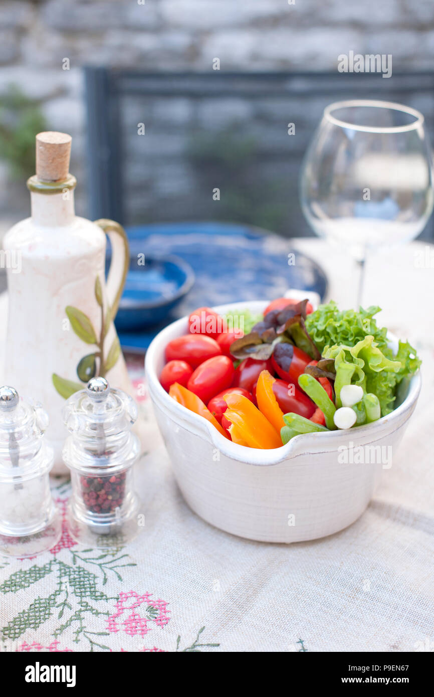 Vegetable salad in a ceramic plate. Lunch in the open air. Healthy food ...