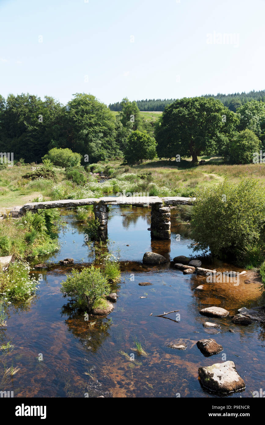 An ancient clapper bridge over the East Dart River at Postbridge ...