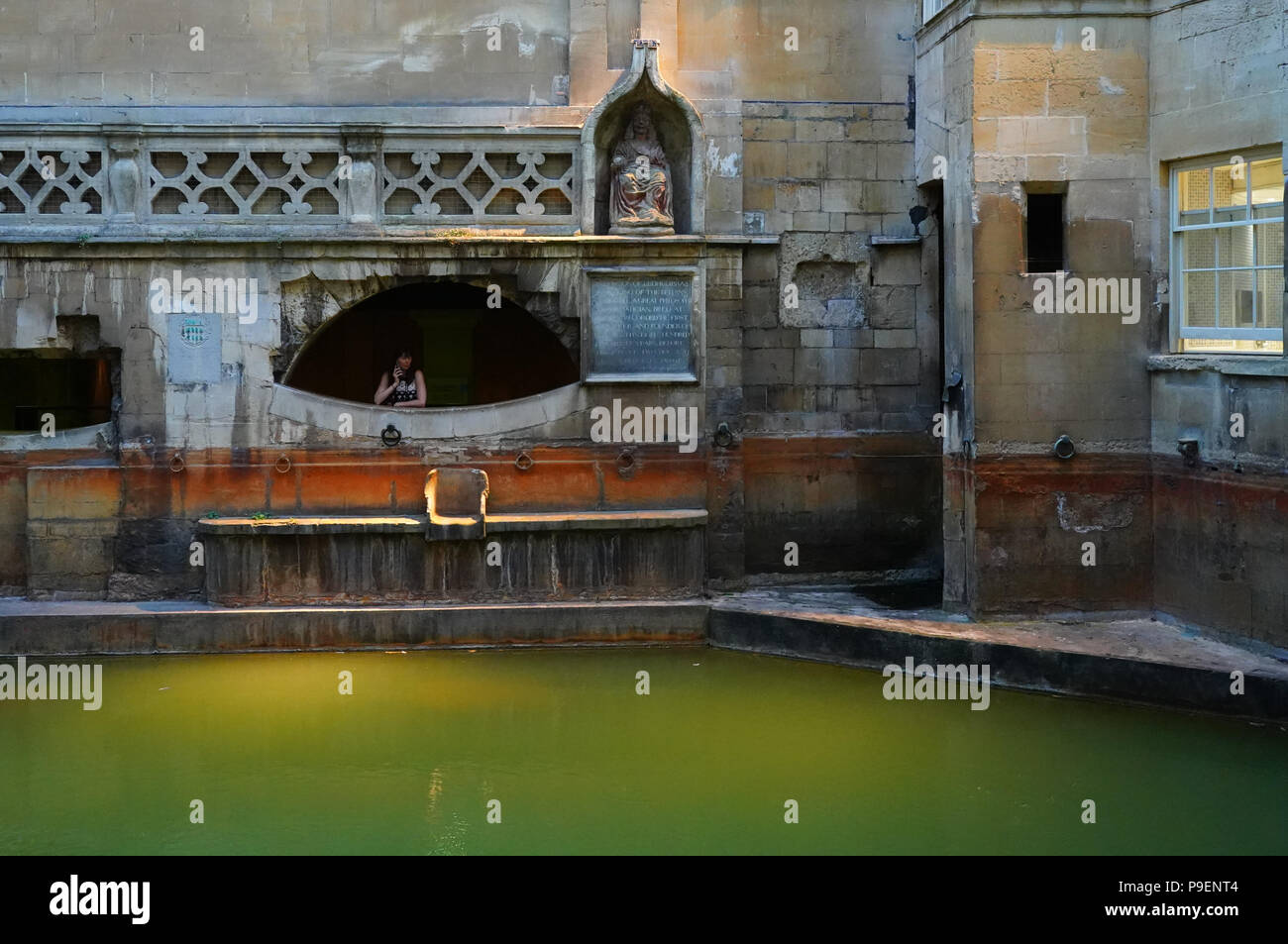 A tourist at the Roman baths in Bath, UK. Photo date: Friday, July 6 ...