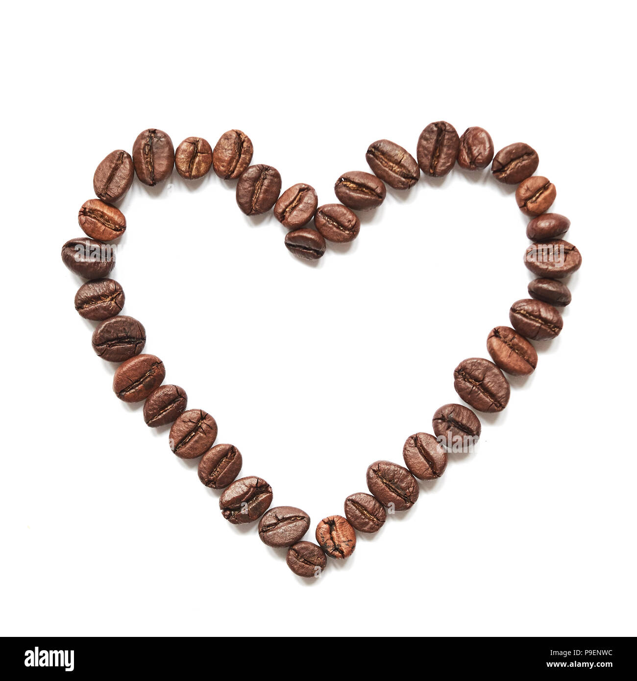 Coffee beans in heart shape white background isolated Stock Photo - Alamy